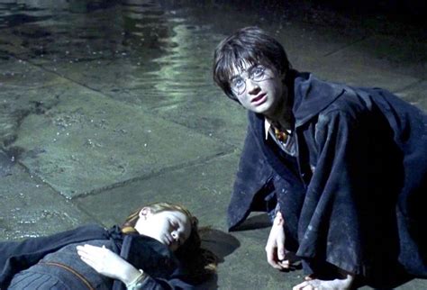 Two People Laying On The Ground Next To Each Other In Front Of Water Puddles