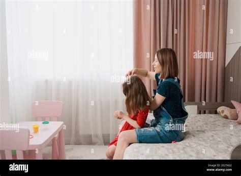 Happy Delightful Aunt Wearing Comfy Jeans Romper Spend Time With Her Cute Lovely Niece Combing