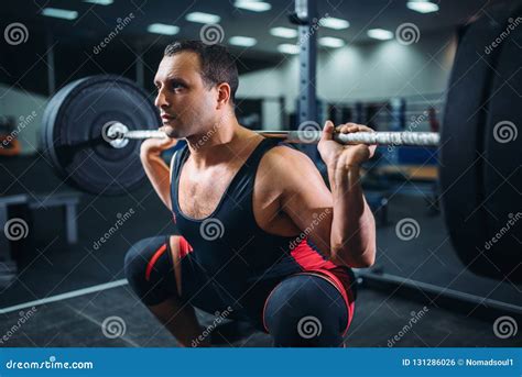 Powerlifter Doing Weightlifting Exercise Man With Naked Torso Lifting