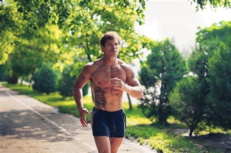 Premium Photo A Strong Attractive Man Running Shirtless Outside In