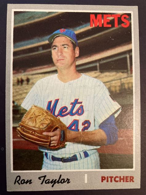 A Baseball Player Holding A Catchers Mitt On Top Of A Card
