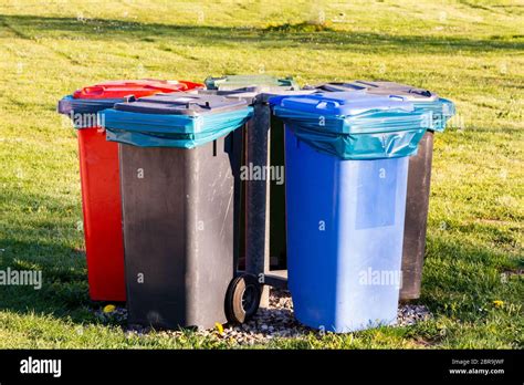 Garbage Cans For Waste Separation And Recycling In A Park Stock Photo