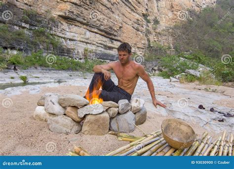 Man Sitting At Primitive Campsite With Fire Stock Photo Image Of Male