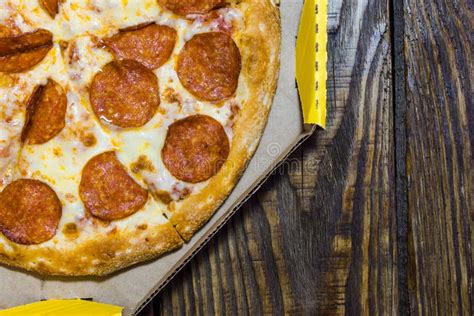 Italian Pizza In Cardboard Box On On The Wood Table A Textured