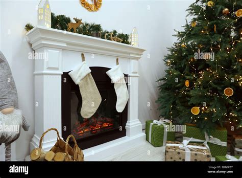 Cozy Living Room With Fireplace And Gifts Under Christmas Tree