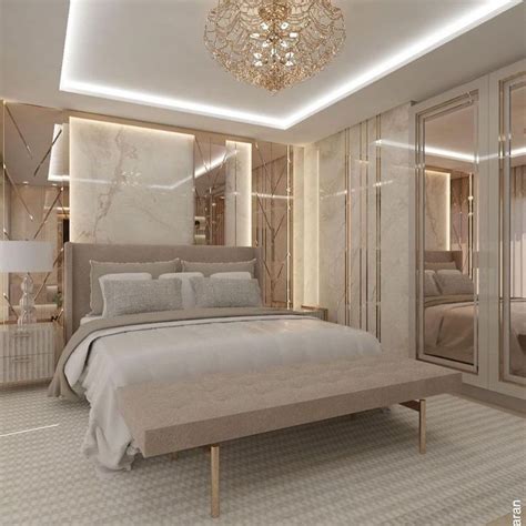 A Large Bed Sitting In The Middle Of A Bedroom Under A Chandelier Above It