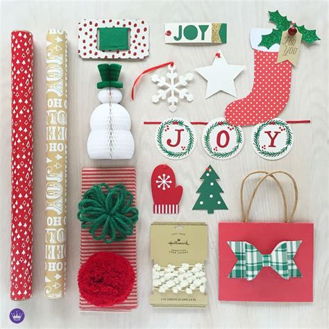 Christmas Decorations And Paper Goods Laid Out On A White Table With