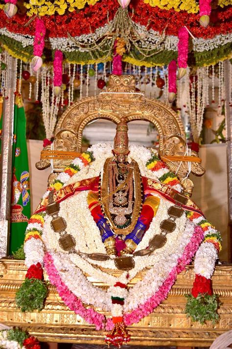 The Statue Is Decorated With Flowers And Garlands