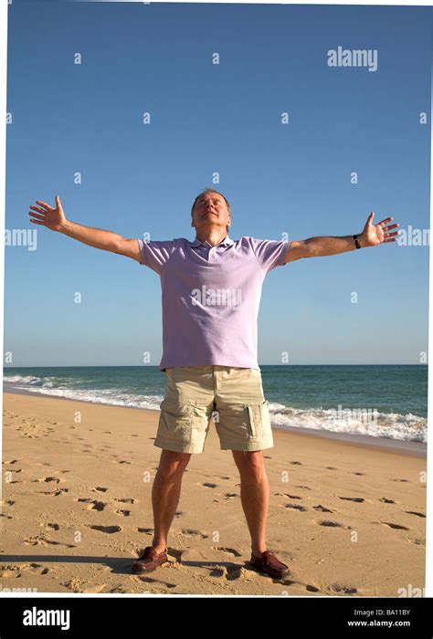 Man With Arms Stretched Out On Beach Stock Photo Alamy