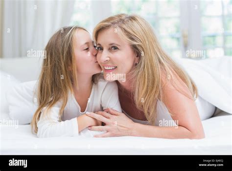 Girl Kissing Mother On Bed Hi Res Stock Photography And Images Alamy