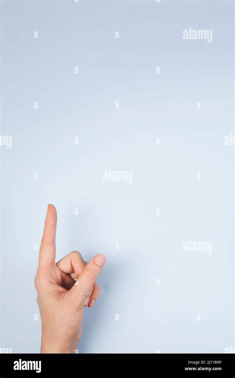 Woman Hand Pointing Up With Index Finger To Something Virtual And