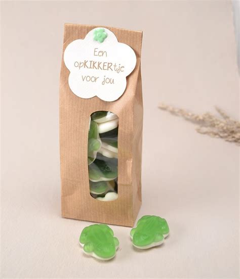 A Bag Filled With Green Leaves Sitting On Top Of A Table