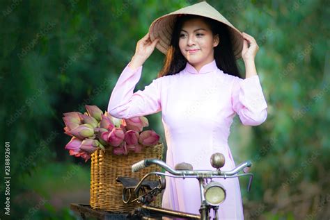 Asian Cute Girl In Vietnamese National Costume Of Vietnam With The