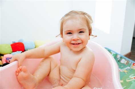 Premium Photo Looking At Camera Baby Kid Girl Sit In Bath One Leg