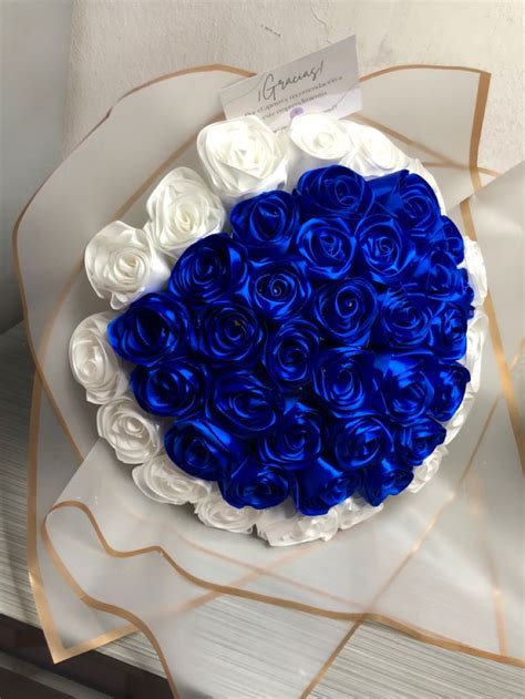 A Large Blue And White Rosette Cake In A Box