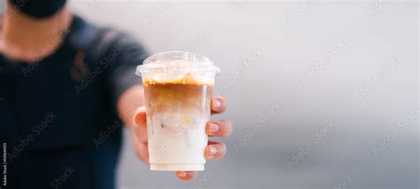 Cold Brewed Iced Latte Coffee Ice Coffee Latte Cup In A Plastic Glass On Barista Hand In