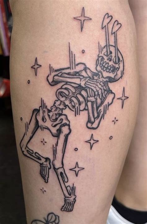 A Woman S Thigh With A Skeleton Tattoo On It And Stars Around Her Legs