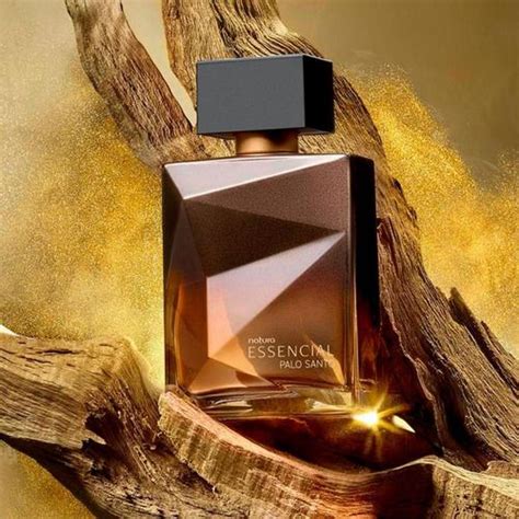 A Bottle Of Perfume Sitting On Top Of A Piece Of Wood With An Artistic