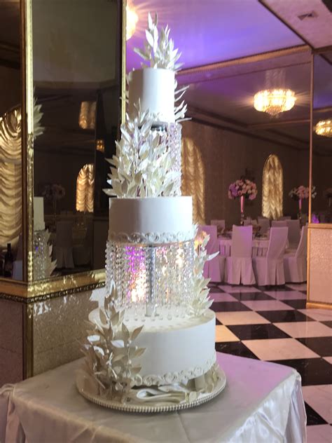 A White Wedding Cake Sitting On Top Of A Table