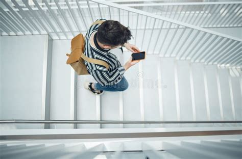 Phone Stairs And Education With A Student Man Walking Down A Staircase