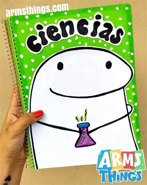 A Hand Holding Up A Green Notebook With An Image Of A Cartoon Character