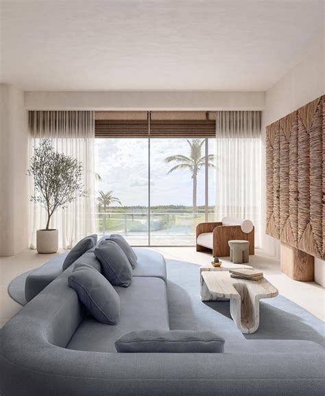 A Living Room Filled With Furniture Next To A Large Glass Window