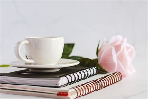 Premium Photo White Coffee Cup On Spiral Notebooks With Sweet Pink