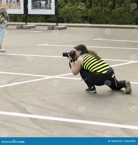 A Female Photographer With DSLR Camera Is Secretly Taking Pictures