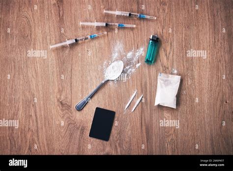 Polvo jeringa y drogas con cuchara en la mesa para la adicción al