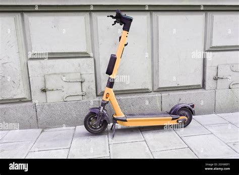 Electric Push Scooter Parked On The Sidewalk Stock Photo Alamy