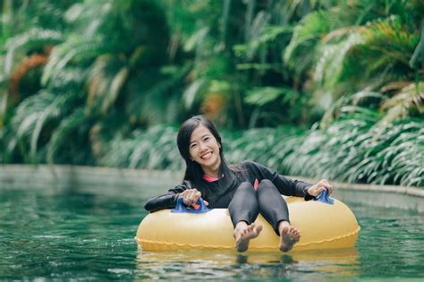 Premium Photo Young Woman Enjoying Tubing At Lazy River Pool