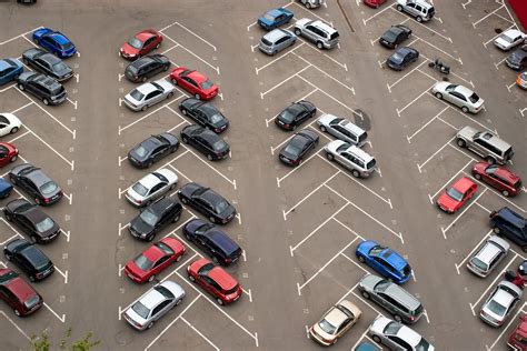 A Parking Lot Filled With Lots Of Different Colored Cars
