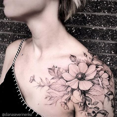 A Woman With A Flower Tattoo On Her Chest