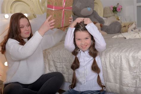 Brunette Sister Girls With Christmas Presents In White Sweaters Having Fun Stock Image Image