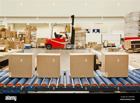 Four Cardboard Boxes On Conveyor Belt Stock Photo Alamy
