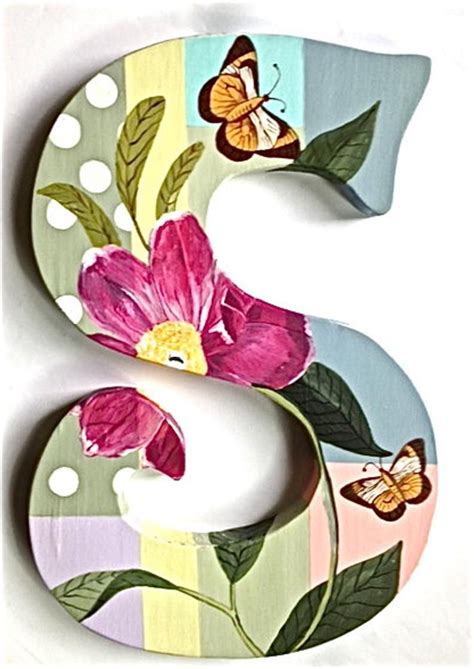 The Letter S Is Decorated With Flowers And Butterflies