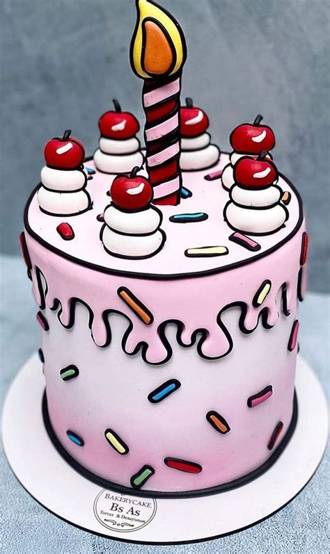 A Pink Birthday Cake With Sprinkles And An Apple On Top Is Shown