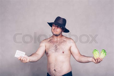 Naked Corpulent Man Giving Pharmaceuticals And Vegetable Stock Image