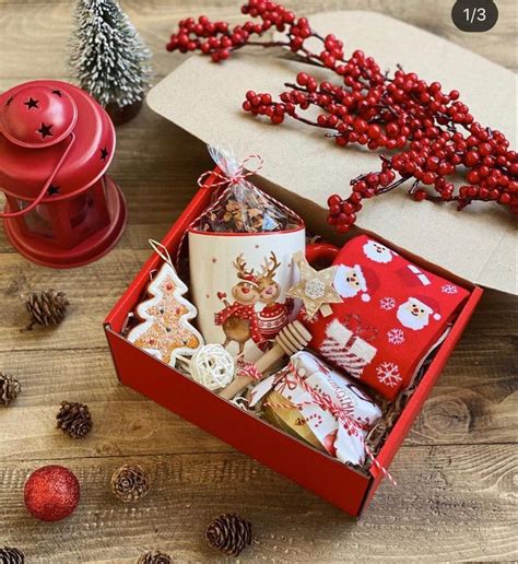 A Red Box Filled With Assorted Christmas Items On Top Of A Wooden Table