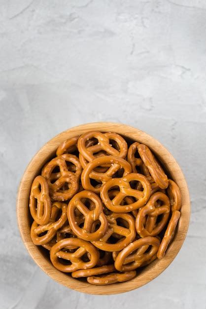 Premium Photo Traditional Salty Mini Pretzels In Wooden Bowl On Gray