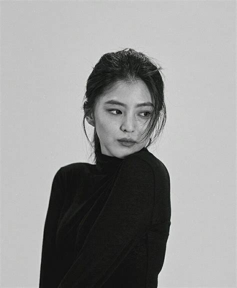 A Black And White Photo Of A Woman With Her Hands On Her Hips Looking