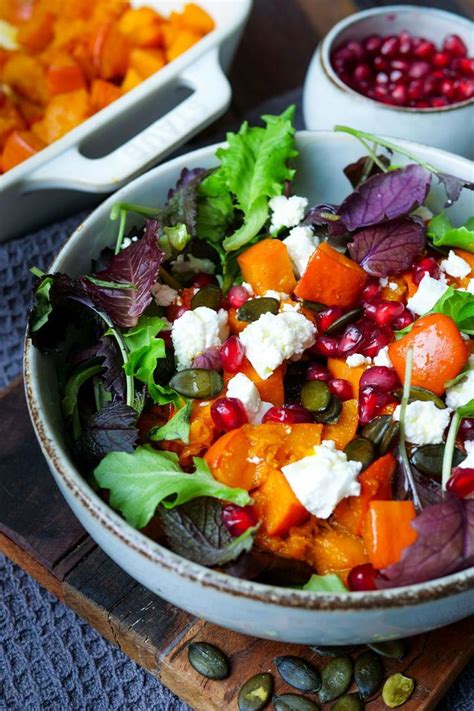 A Salad With Carrots Pomegranate And Feta Cheese In A Bowl