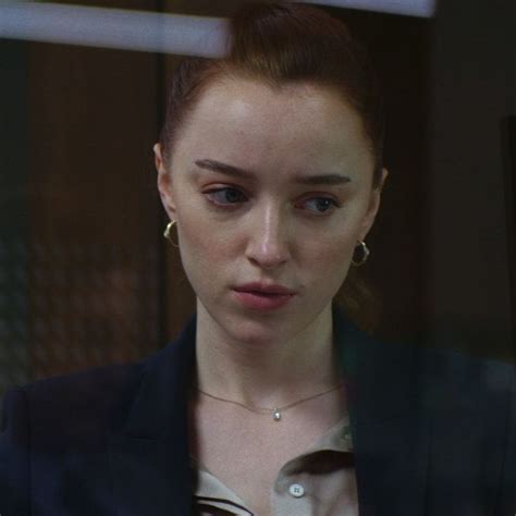 A Woman In A Suit Looking At The Camera