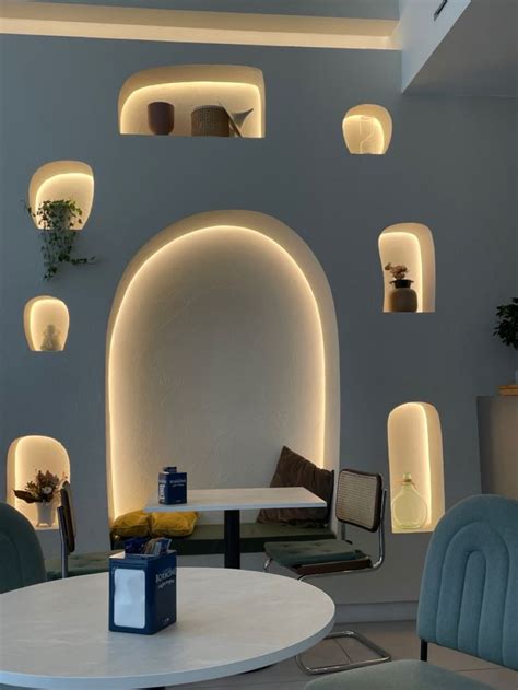 The Interior Of A Restaurant With White Walls And Blue Chairs Round