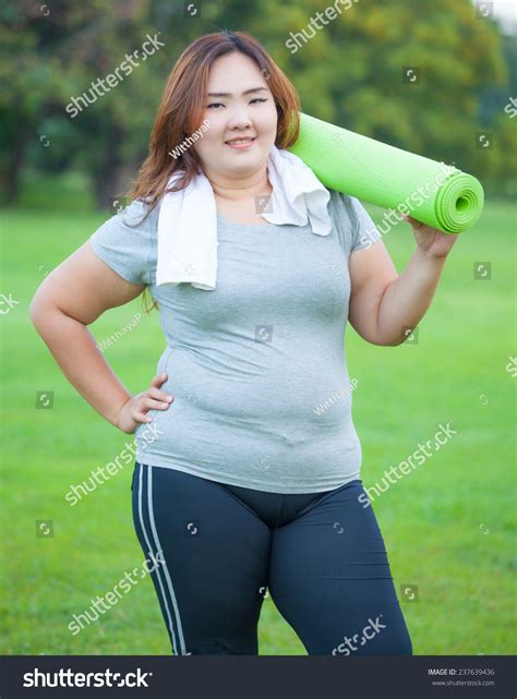 Pretty Fat Asian Woman Going To Work Out With Her Yoga Mat Stock Photo