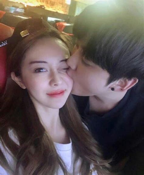 A Man Kissing A Woman On The Cheek