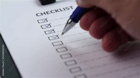 Close Up Businessman Tick Off Or Marking With Blue Pen On Checklist