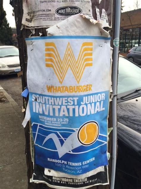 A Sign On A Pole That Has Been Vandalized With Stickers And Advertises
