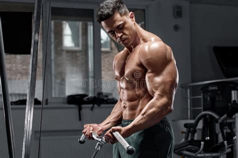 Muscular Man Working Out In Gym Doing Exercise For Biceps Strong Male