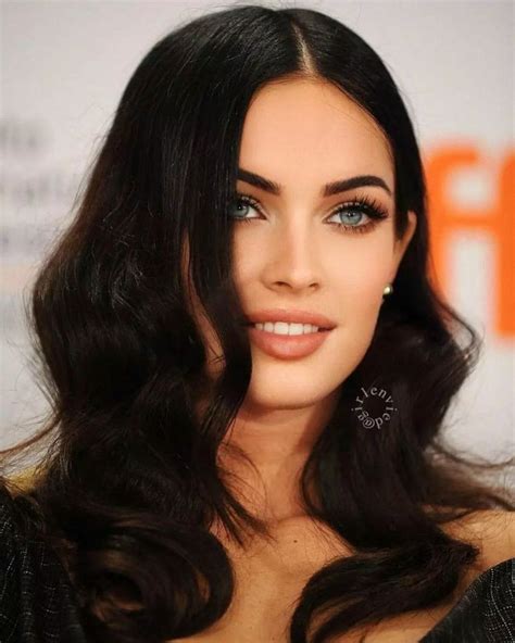 A Woman With Long Black Hair And Blue Eyes